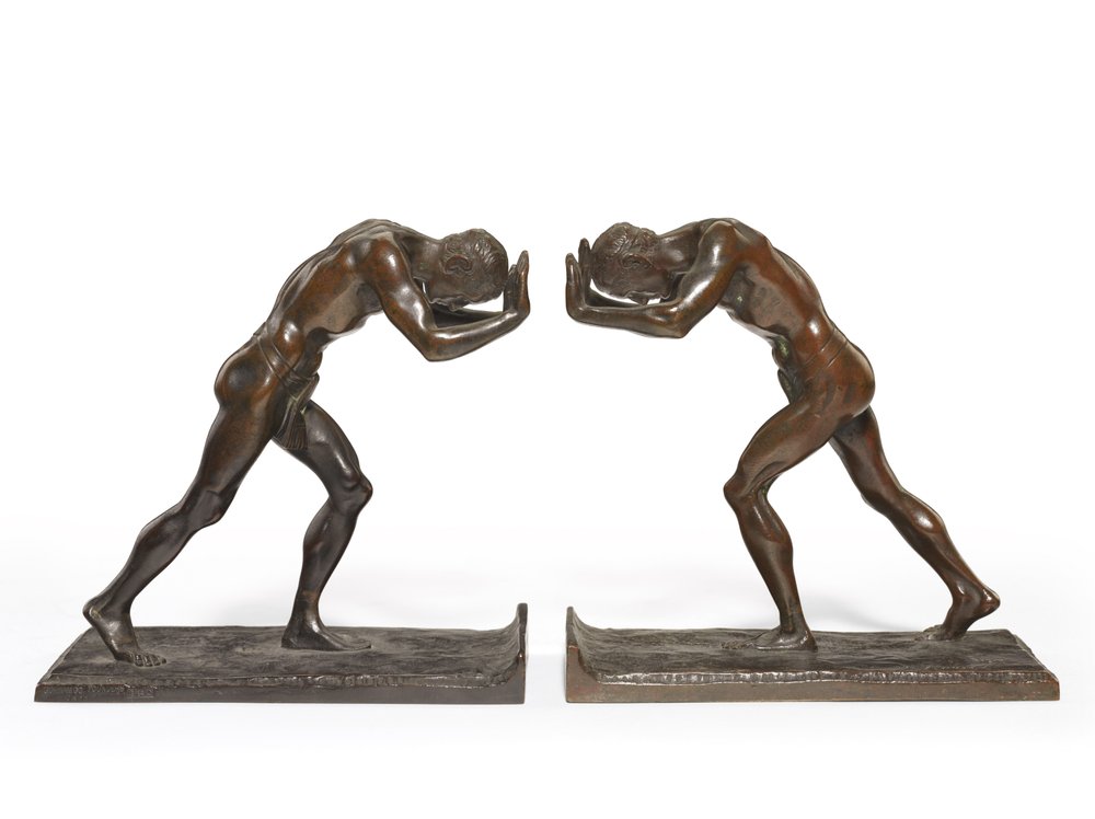 Pushing Men, a pair of bookends by Isidore Konti