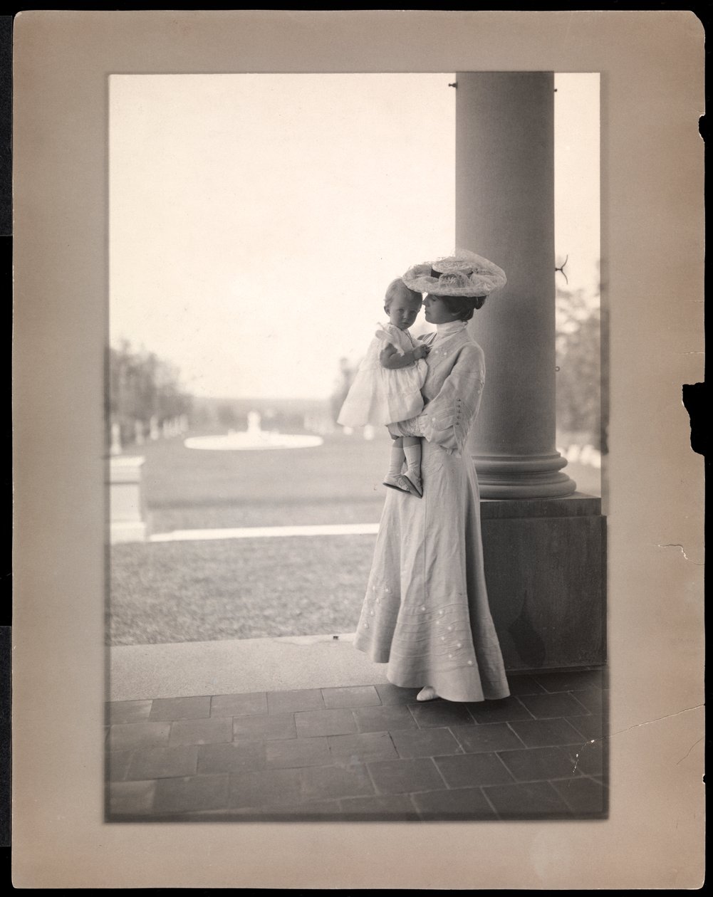 Mrs. Clarence Mackay and child in the portico of Harbor Hill, Long ...