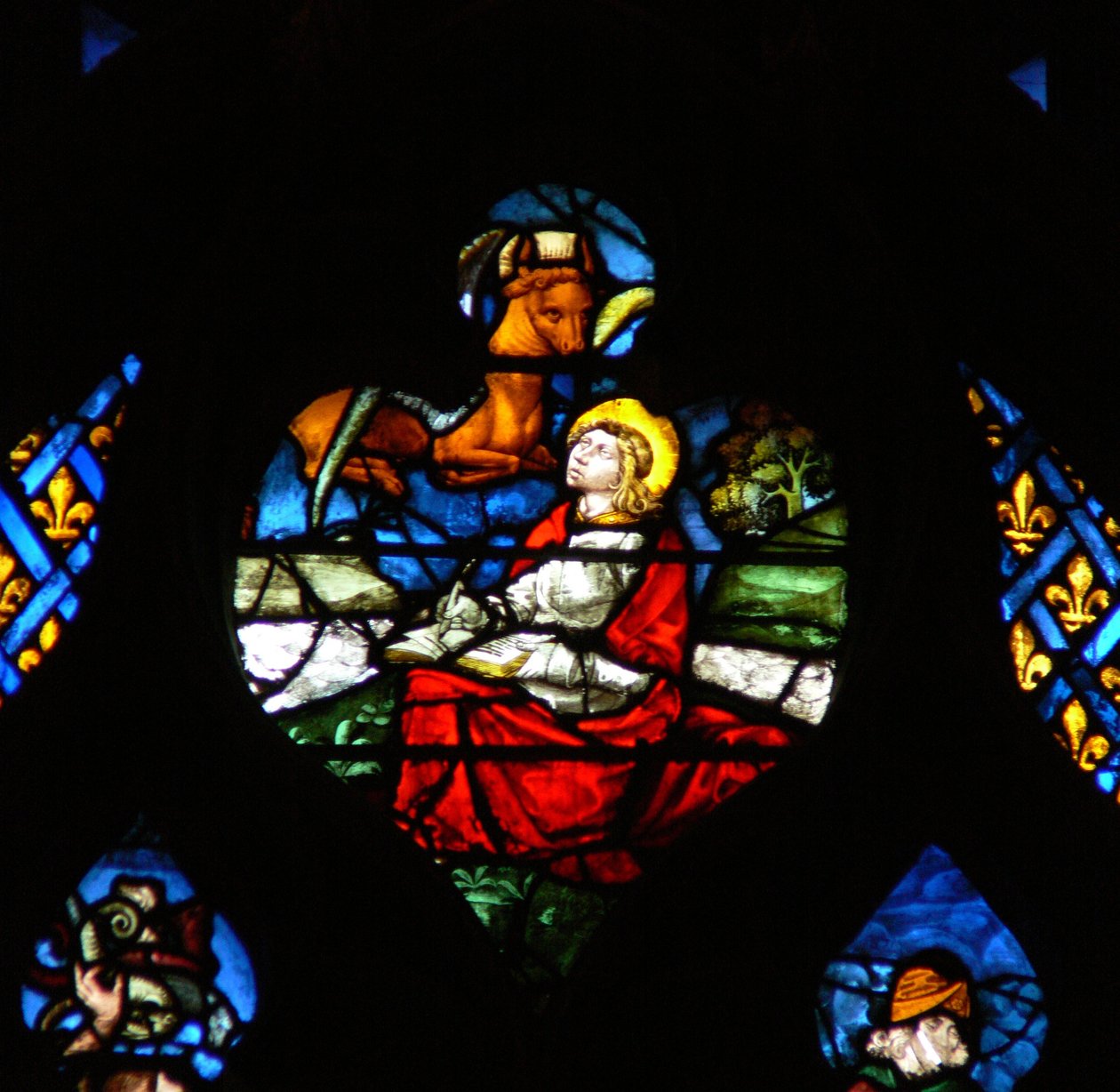 The west rose window depicting a scene from the Book of Revelation ...