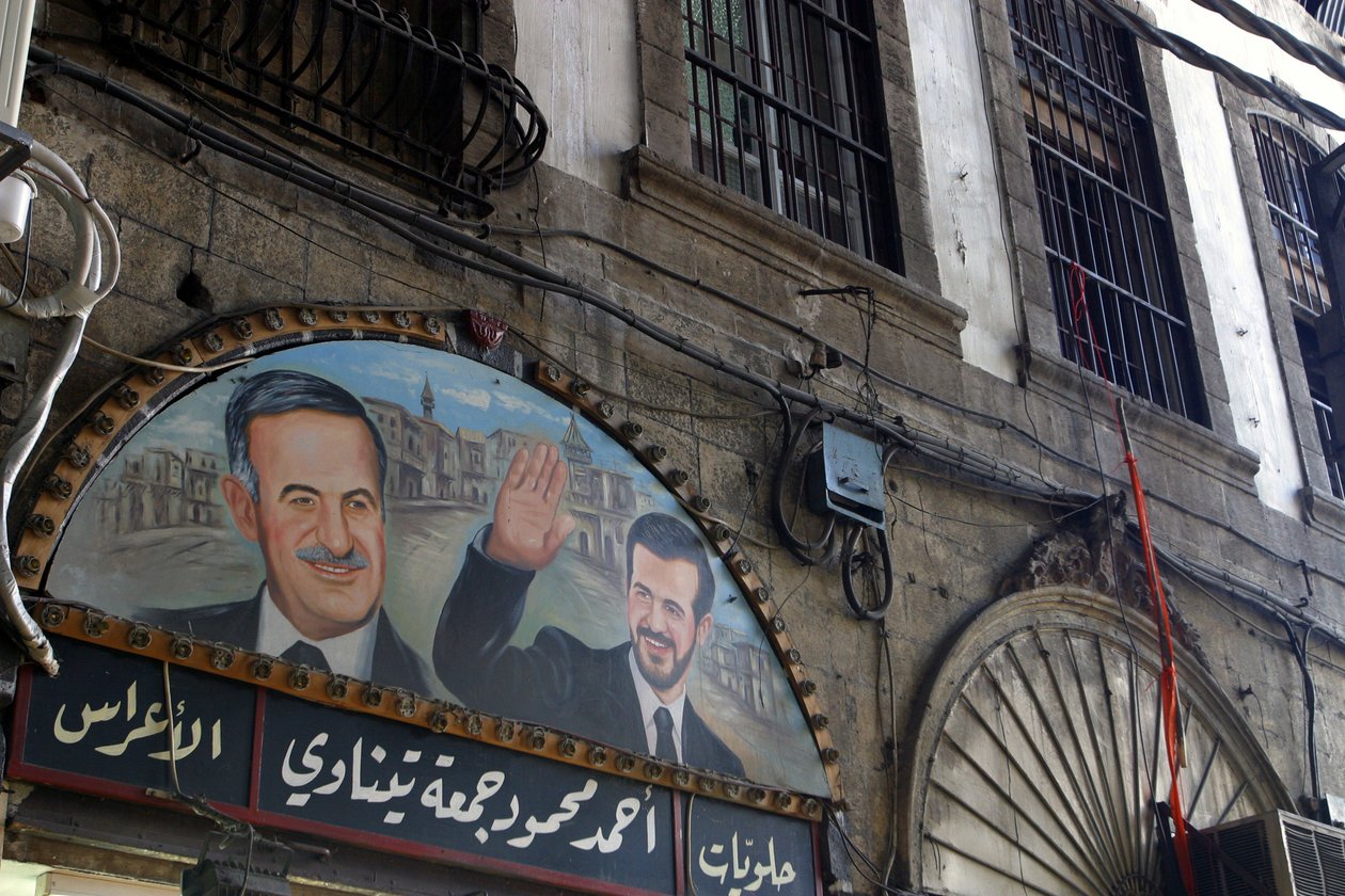 Painting by President Assad and his son Bassel above the souk in ...